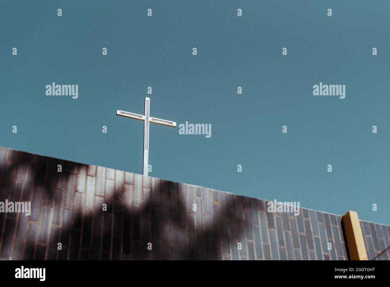 Low angle shot of a metallic cross on a structure under blue sky Stock ...