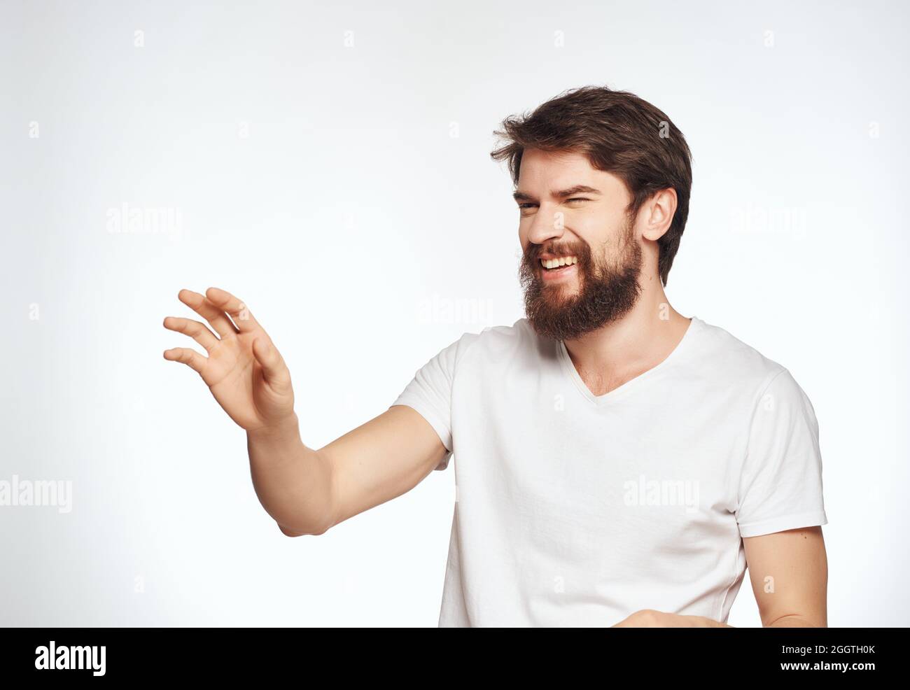 emotional man in a white t-shirt hand gestures anger Lifestyle Stock ...