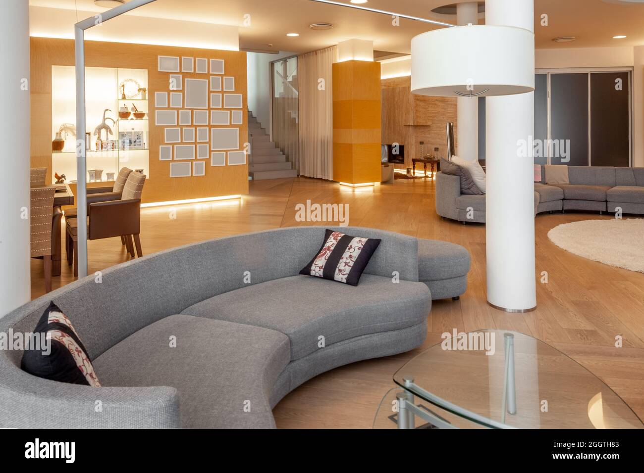 Spacious open plan living room with soft couches in sitting area Stock ...