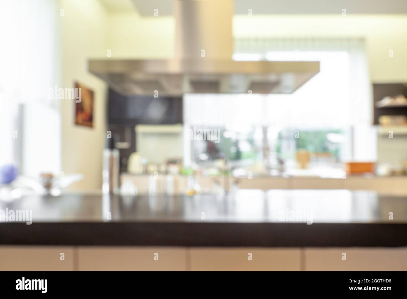 Blurred kitchen interior with modern functional appliances and ...
