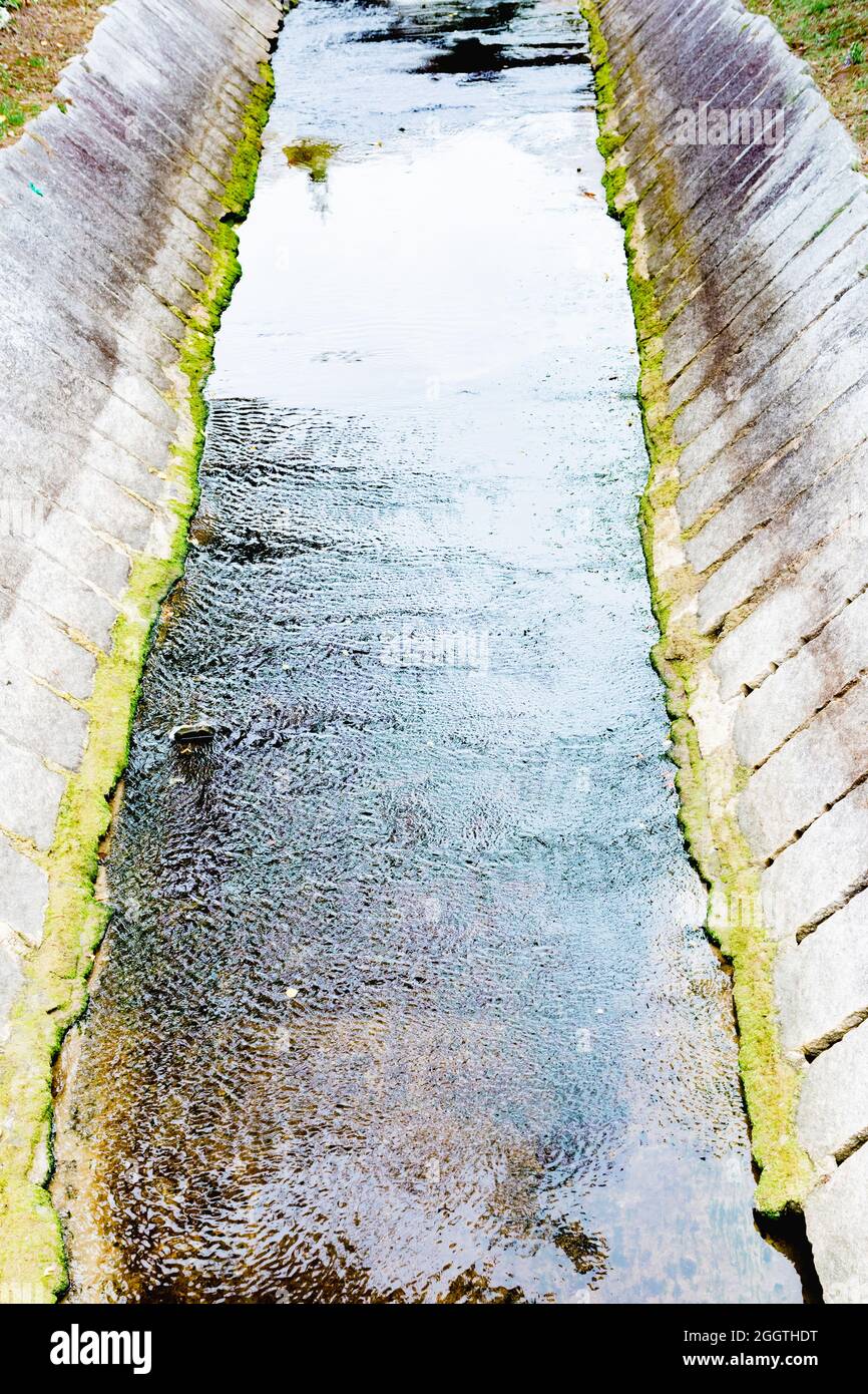 Water moves along a concrete channel towards anywhere Stock Photo - Alamy