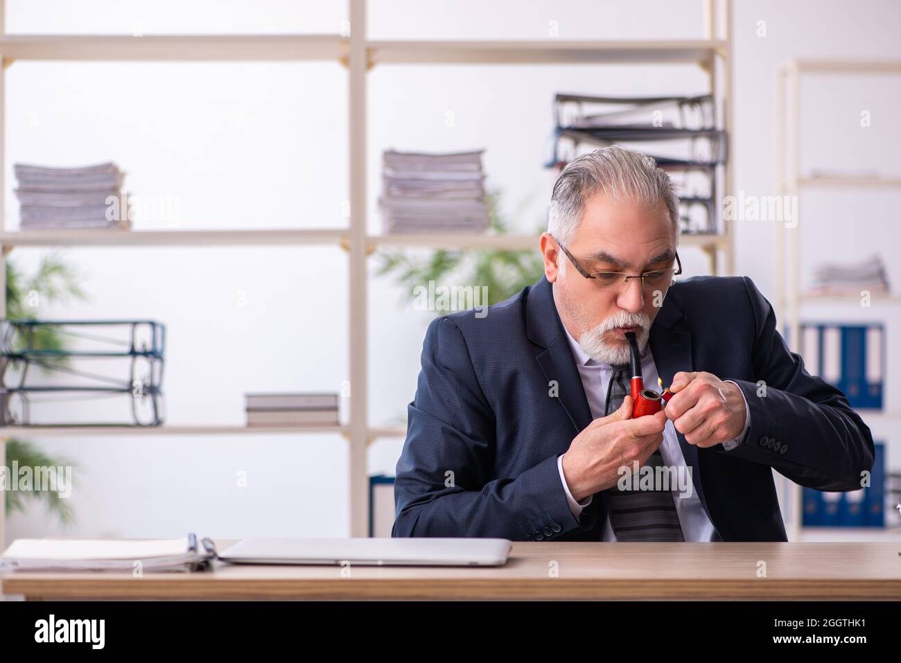Old businessman employee smoking pipe at workplace Stock Photo - Alamy