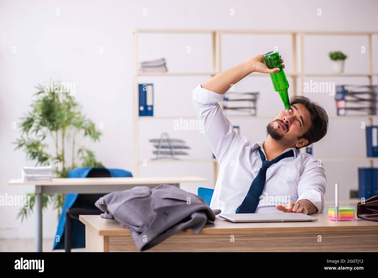 Male alcohol addicted employee sitting in the office Stock Photo - Alamy