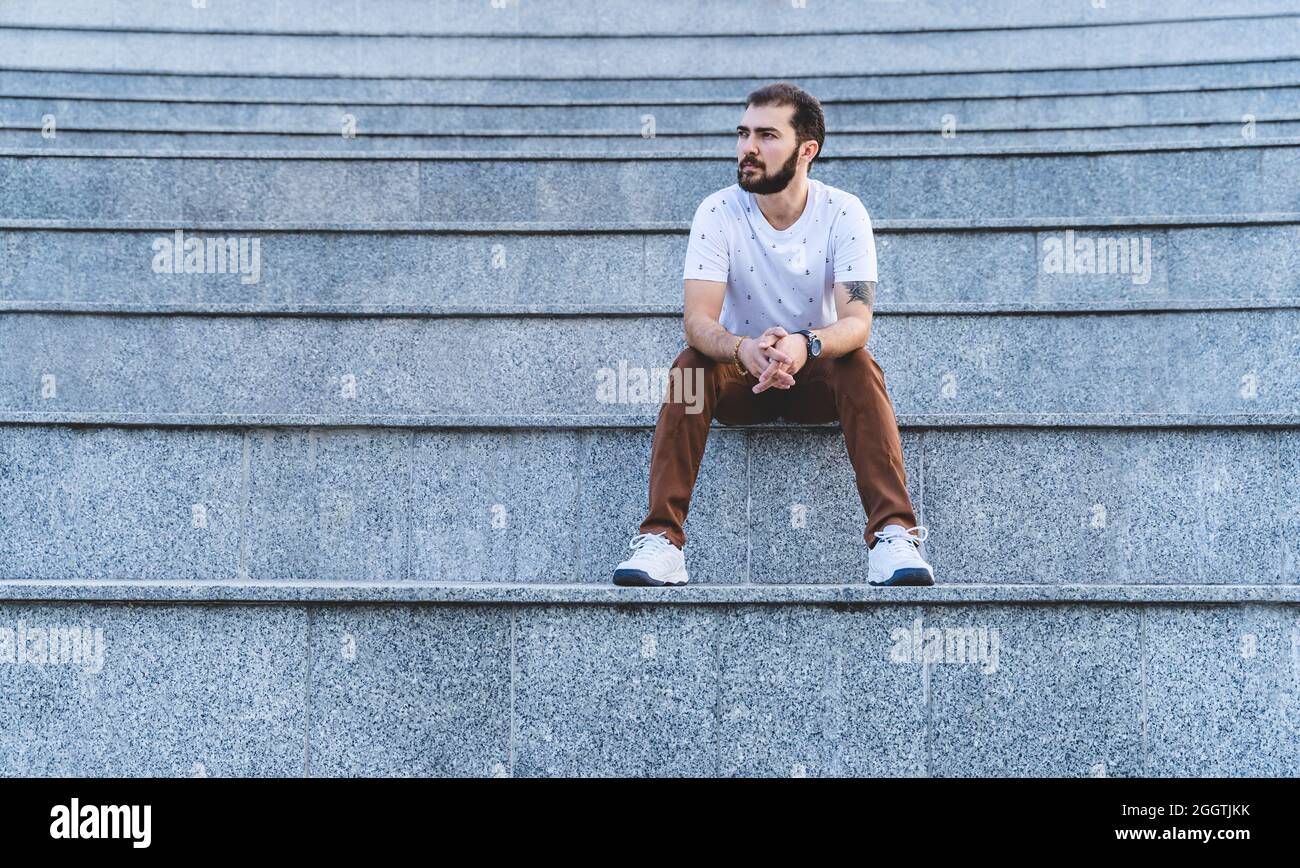 Lonely man sitting on stairs hi-res stock photography and images - Alamy