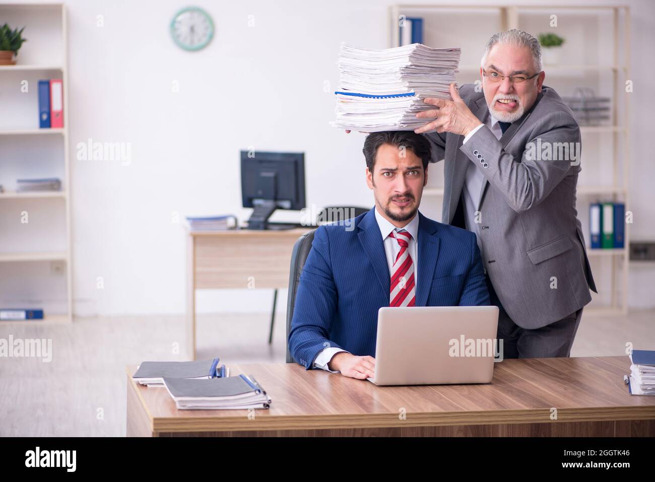 Two employees and too much work in the office Stock Photo - Alamy