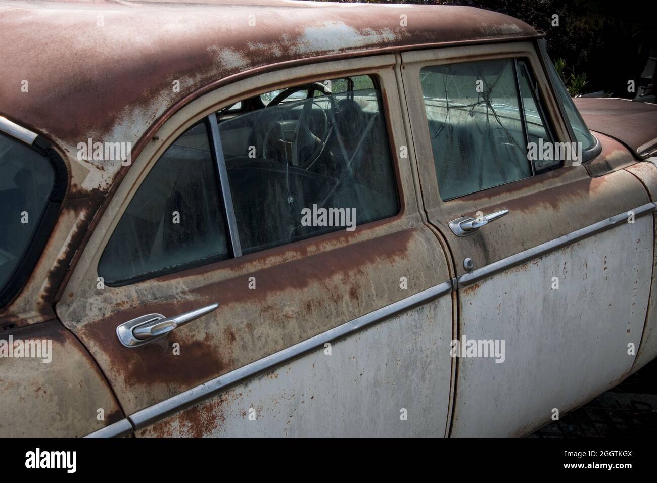 Partial view of the right side of an old rusted car photographed from ...