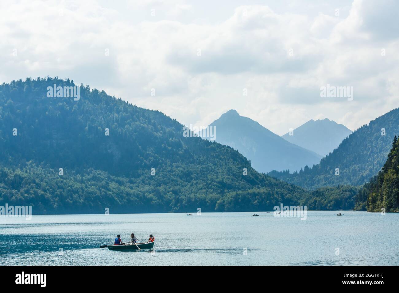 Rest on a mountain lake near Neuschwanstein. family is sitting in the ...