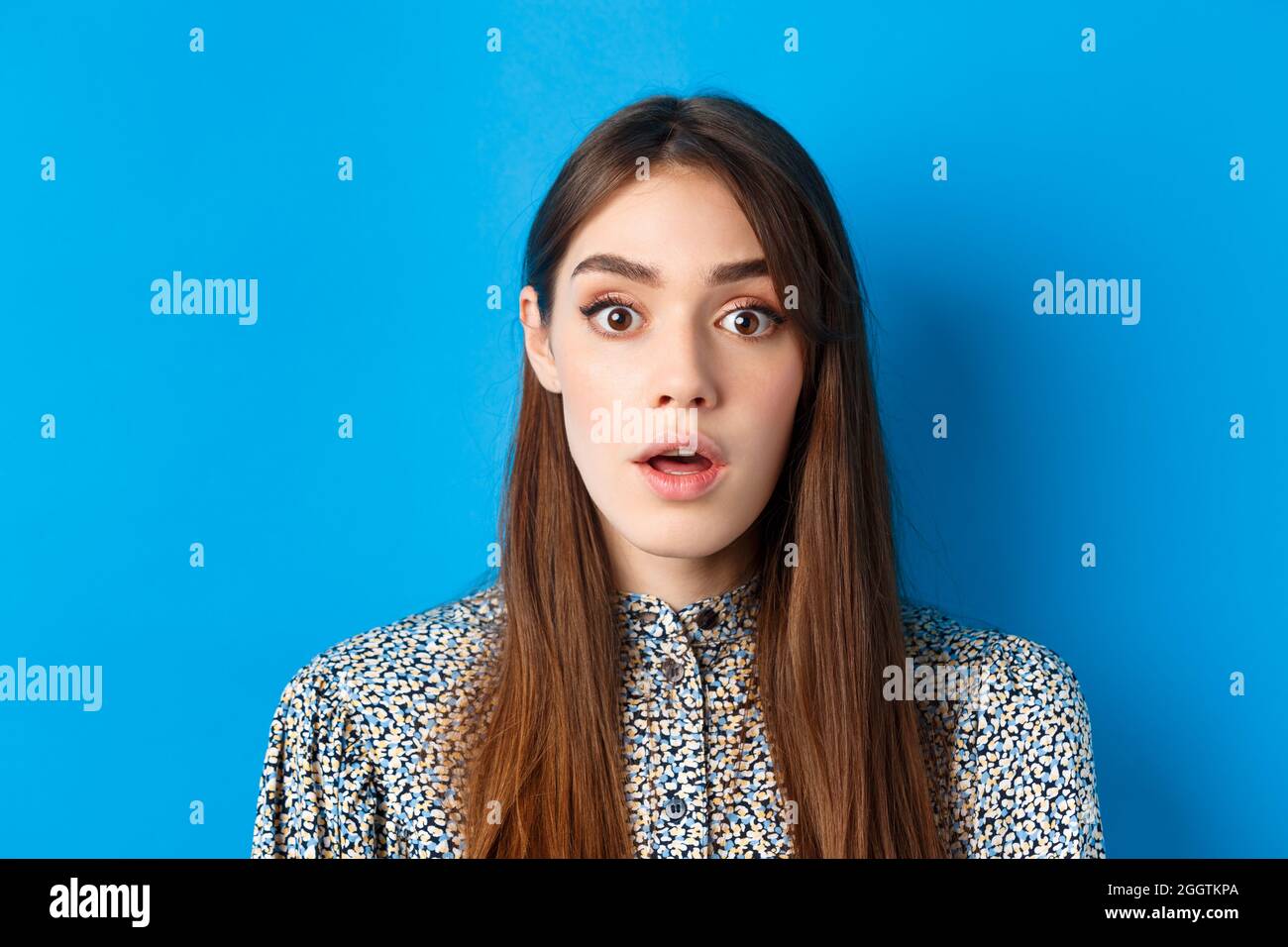 Close-up of excited pretty woman with long natural hair and makeup ...