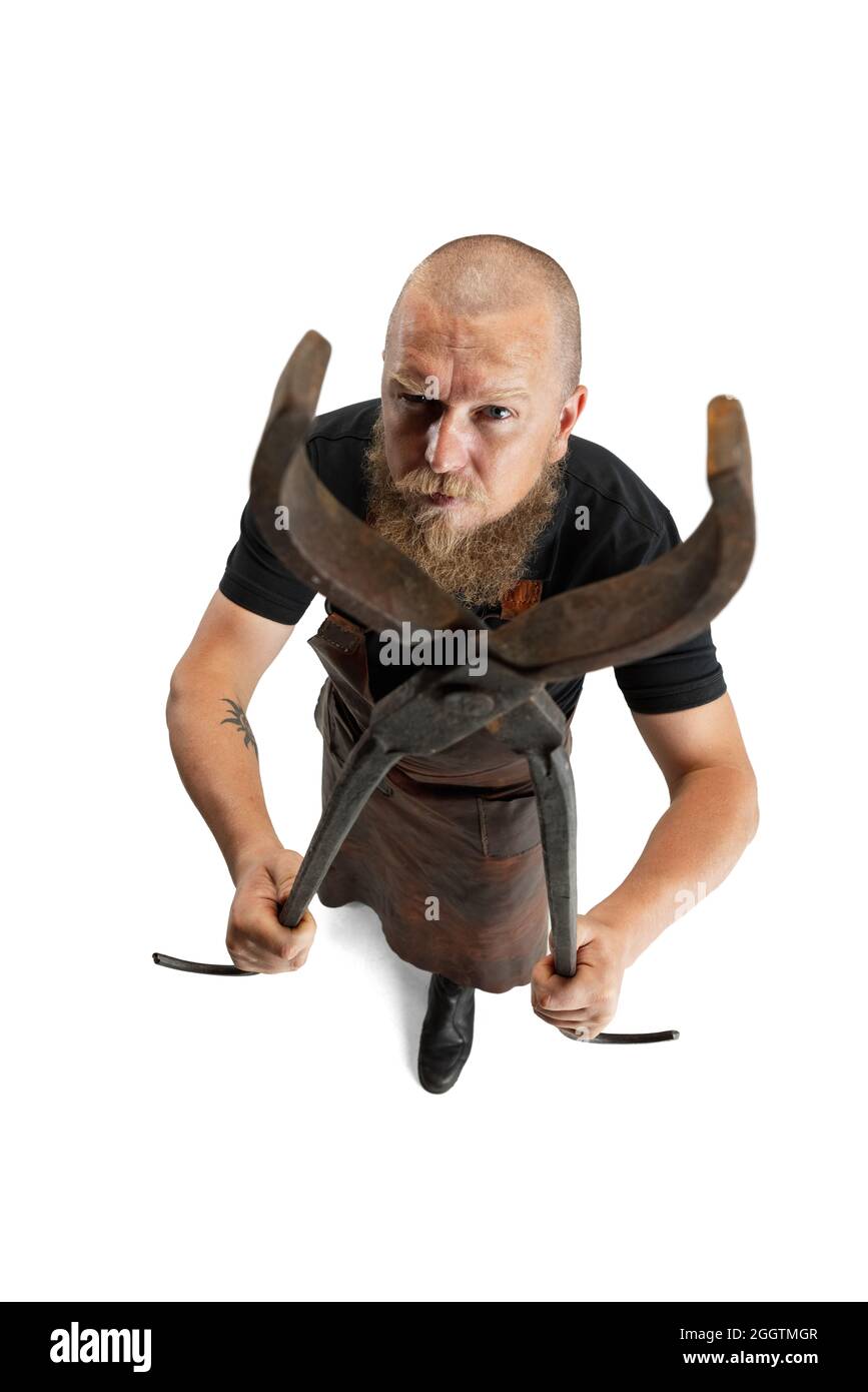 High angle view of bearded bald man, blacksmith wearing leather apron ...