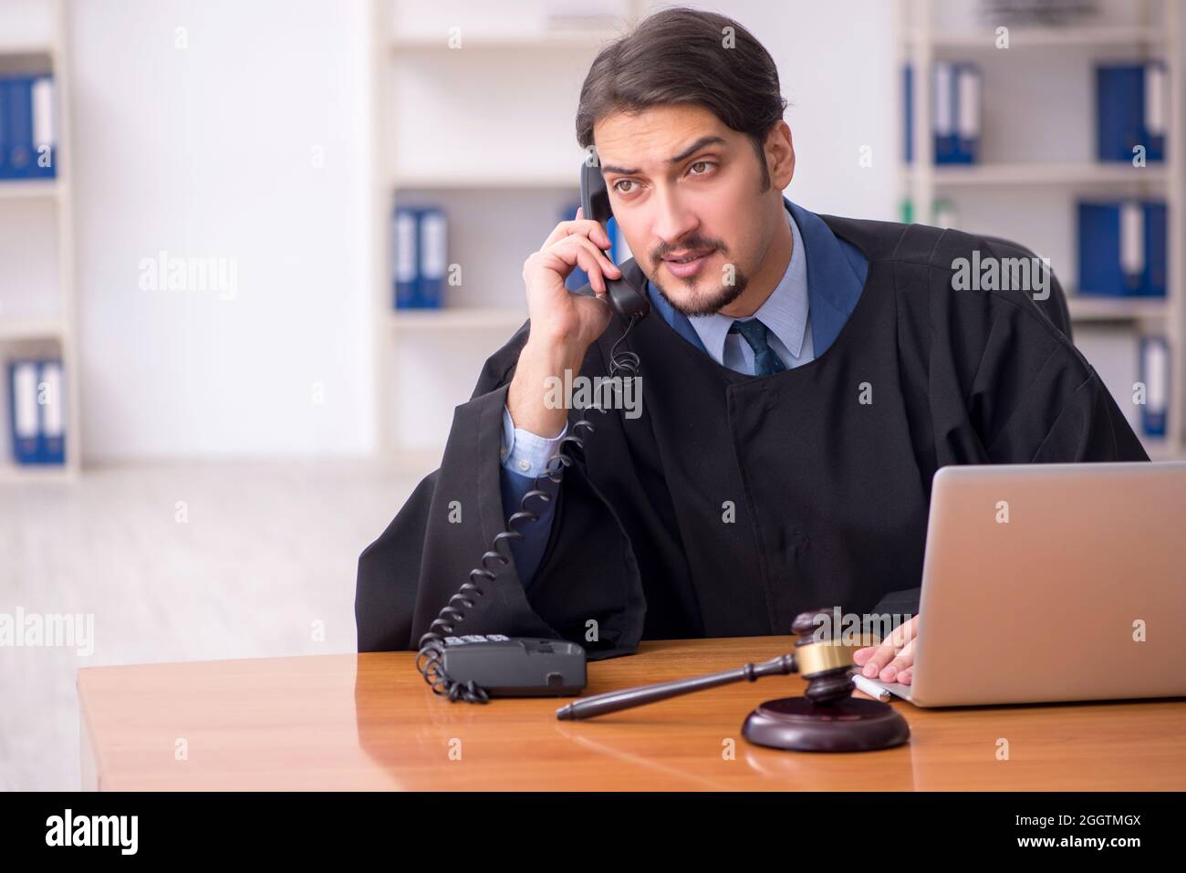 Young judge working in the courtroom Stock Photo - Alamy