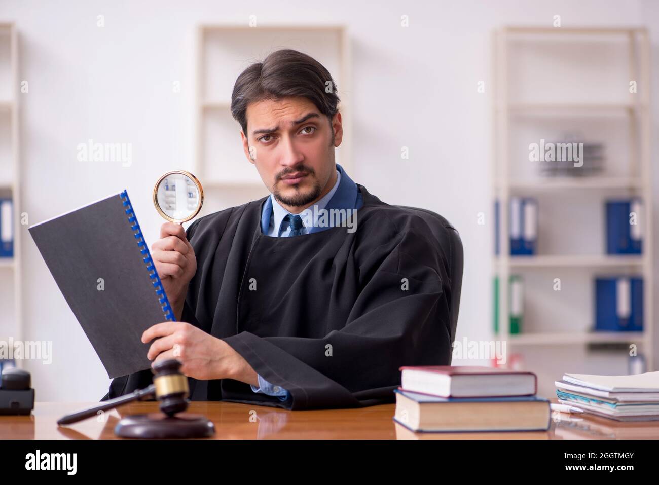 Young judge working in the courtroom Stock Photo - Alamy