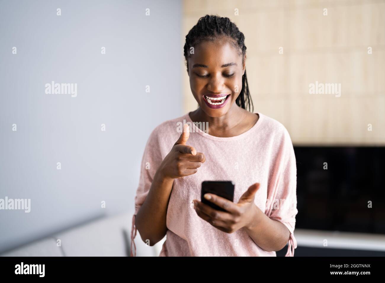 Happy Text Message On Mobile Phone. Young African Person Stock Photo ...