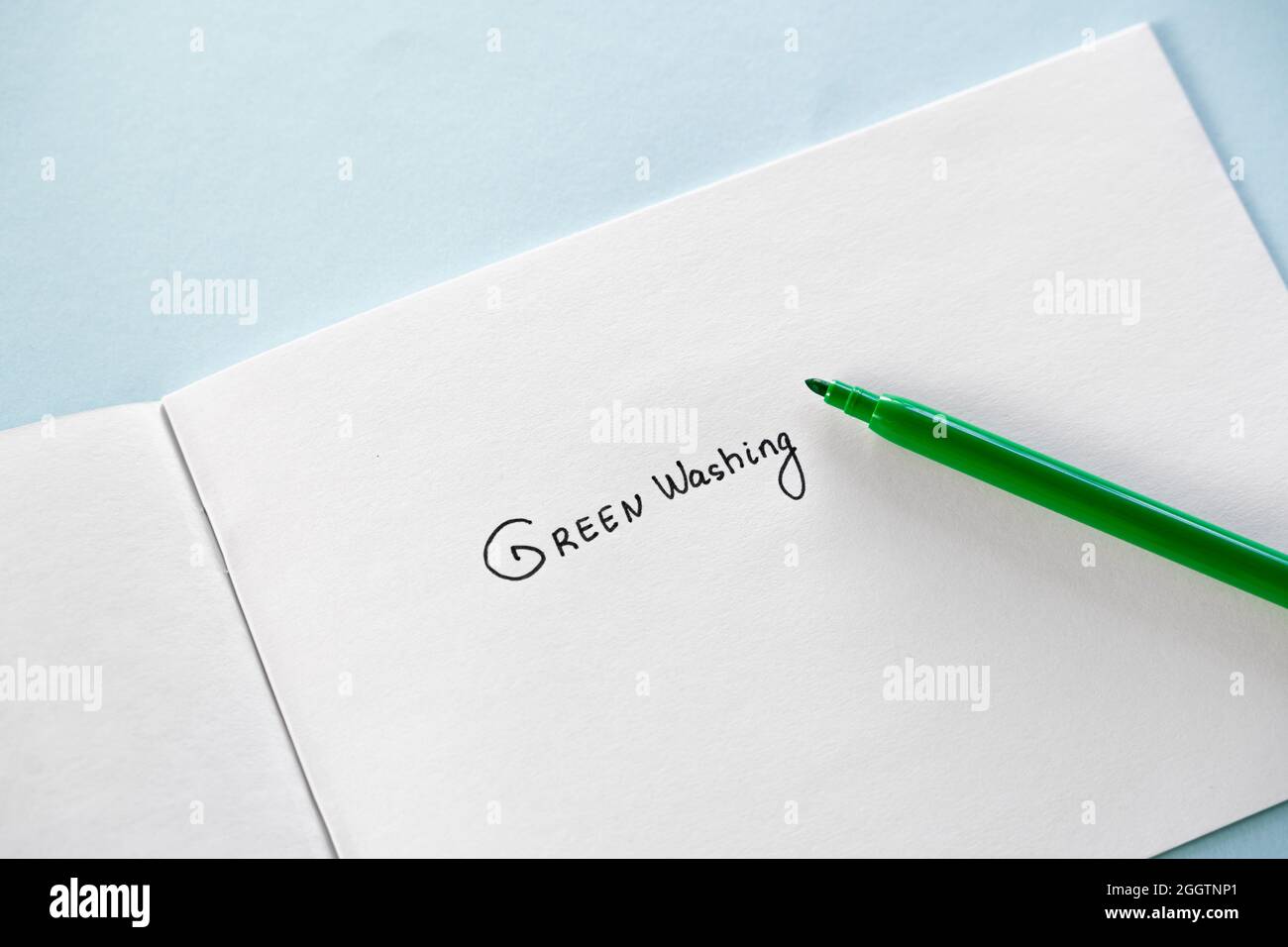Greenwashing concept. Drawing on paper with text and green marker ...