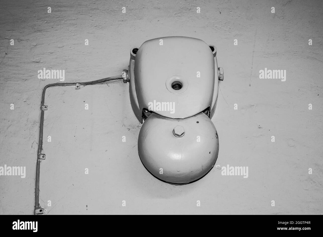 Grayscale school bell on the wall Stock Photo - Alamy