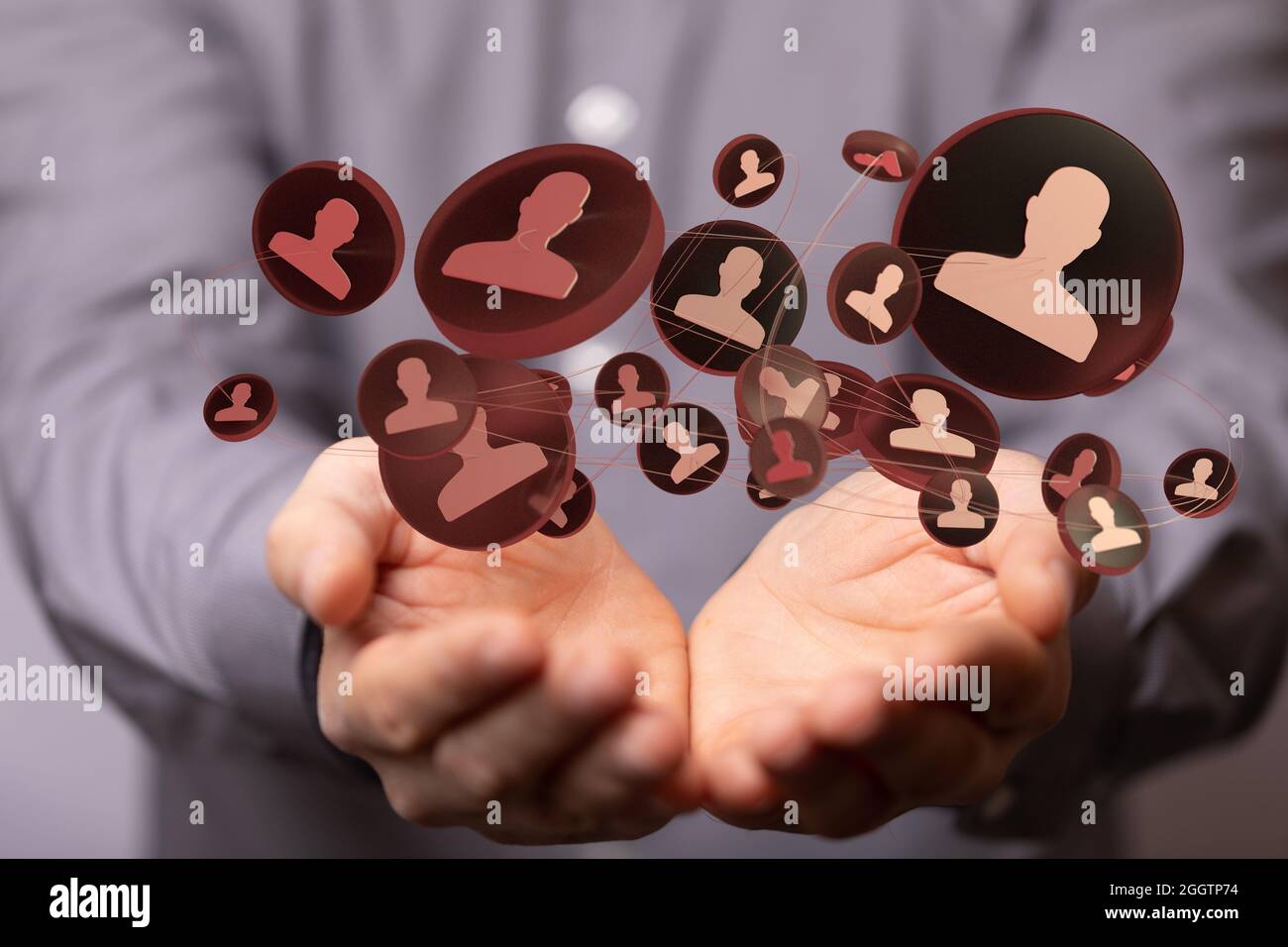 Hand holding person icons - the concept of networking Stock Photo - Alamy