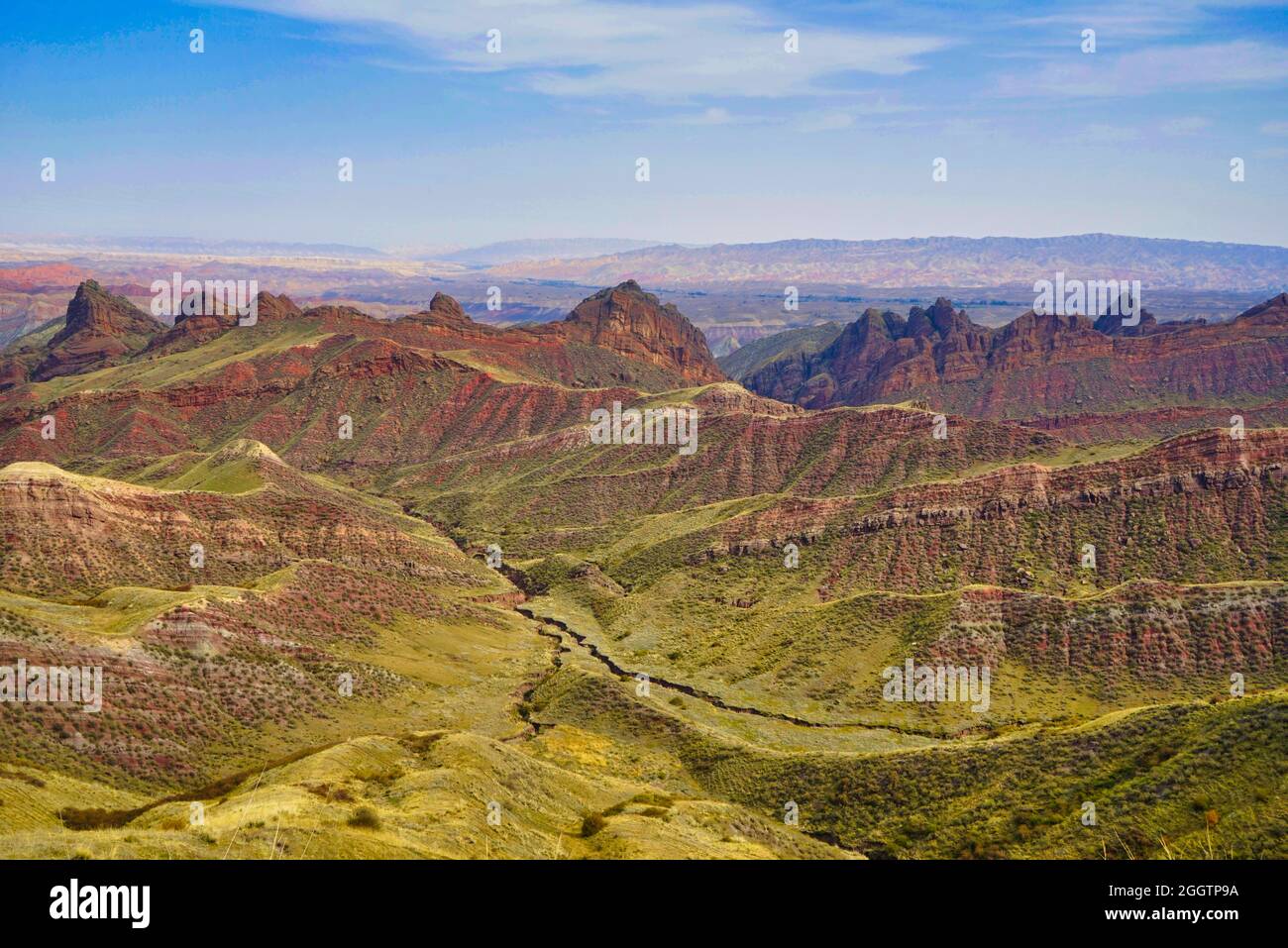 Hills formed by erosion of colored rocks with reddish-yellow and orange ...