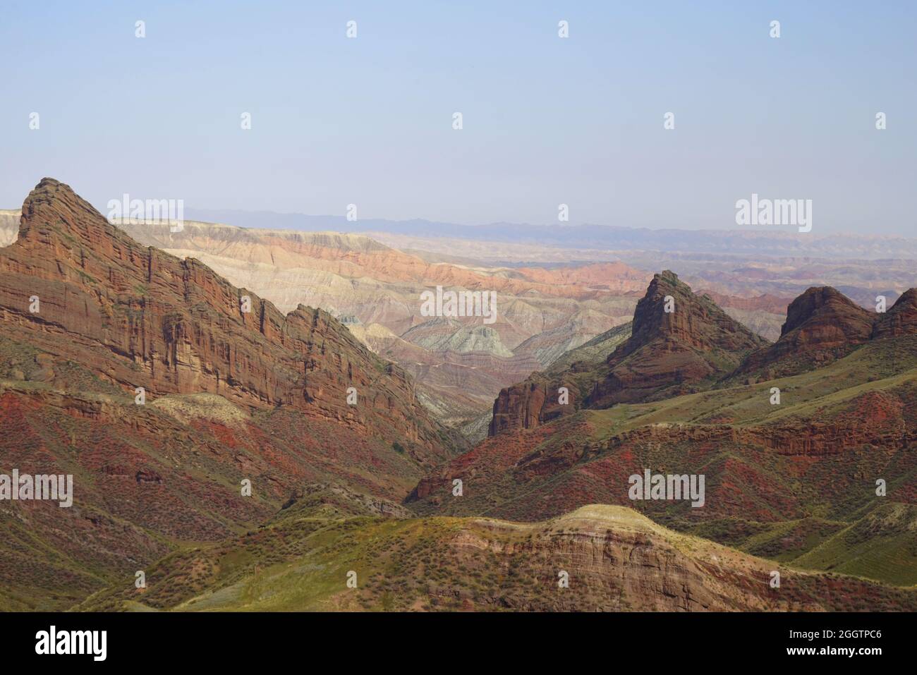 Hills formed by erosion of colored rocks with reddish-yellow and orange ...