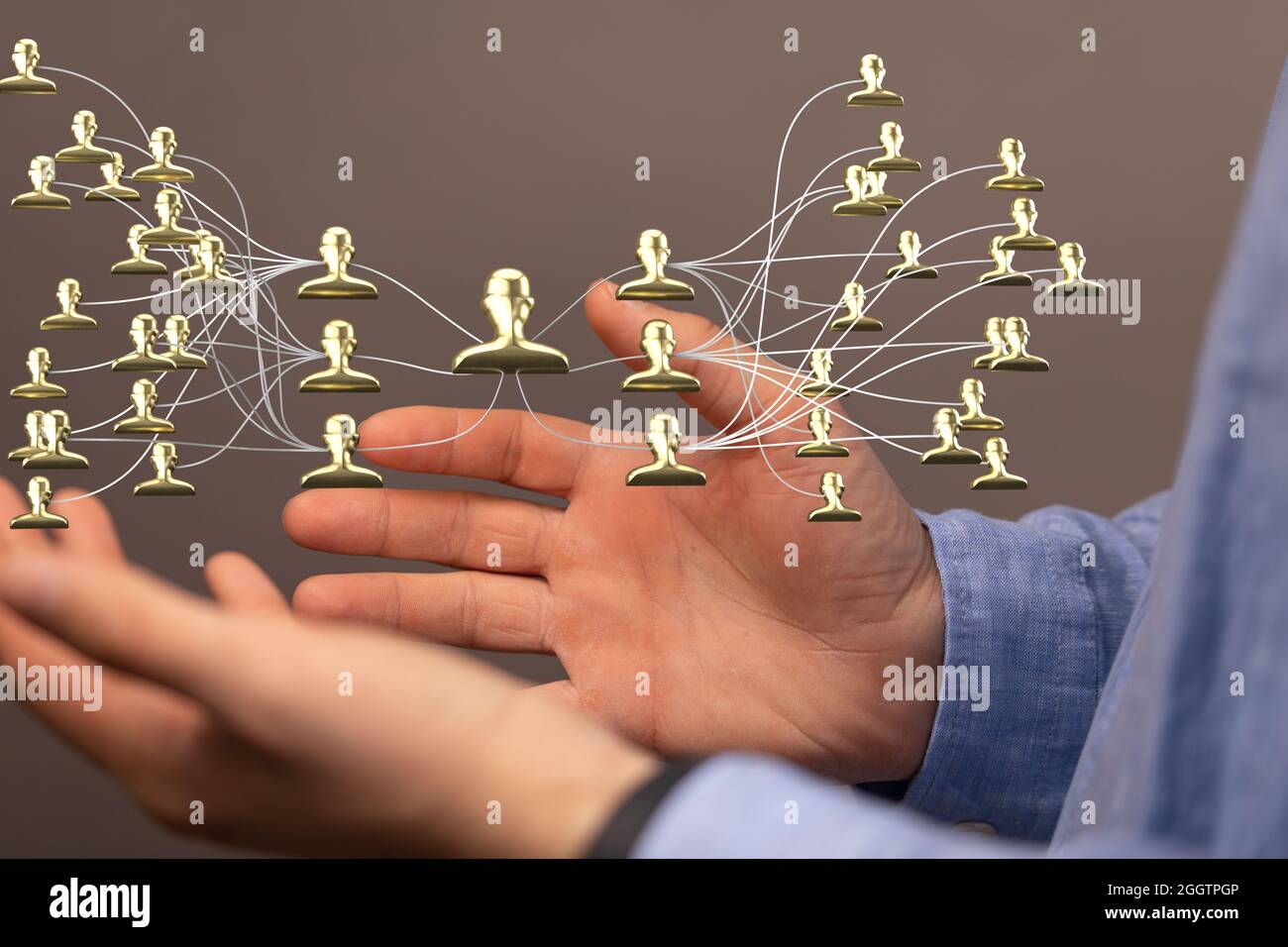 Hand holding person icons - the concept of networking Stock Photo - Alamy