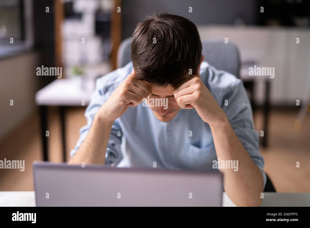 Unhappy Sad Man With Migraine Using Laptop Computer Stock Photo - Alamy