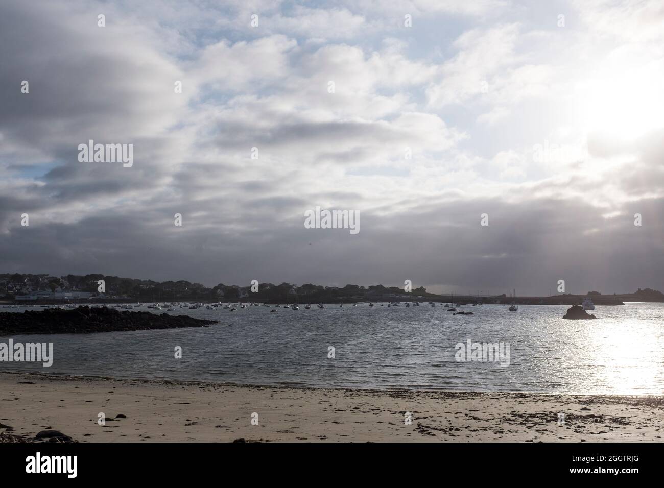 The sun sets over the port on a moody, windy, summer evening in Primel ...