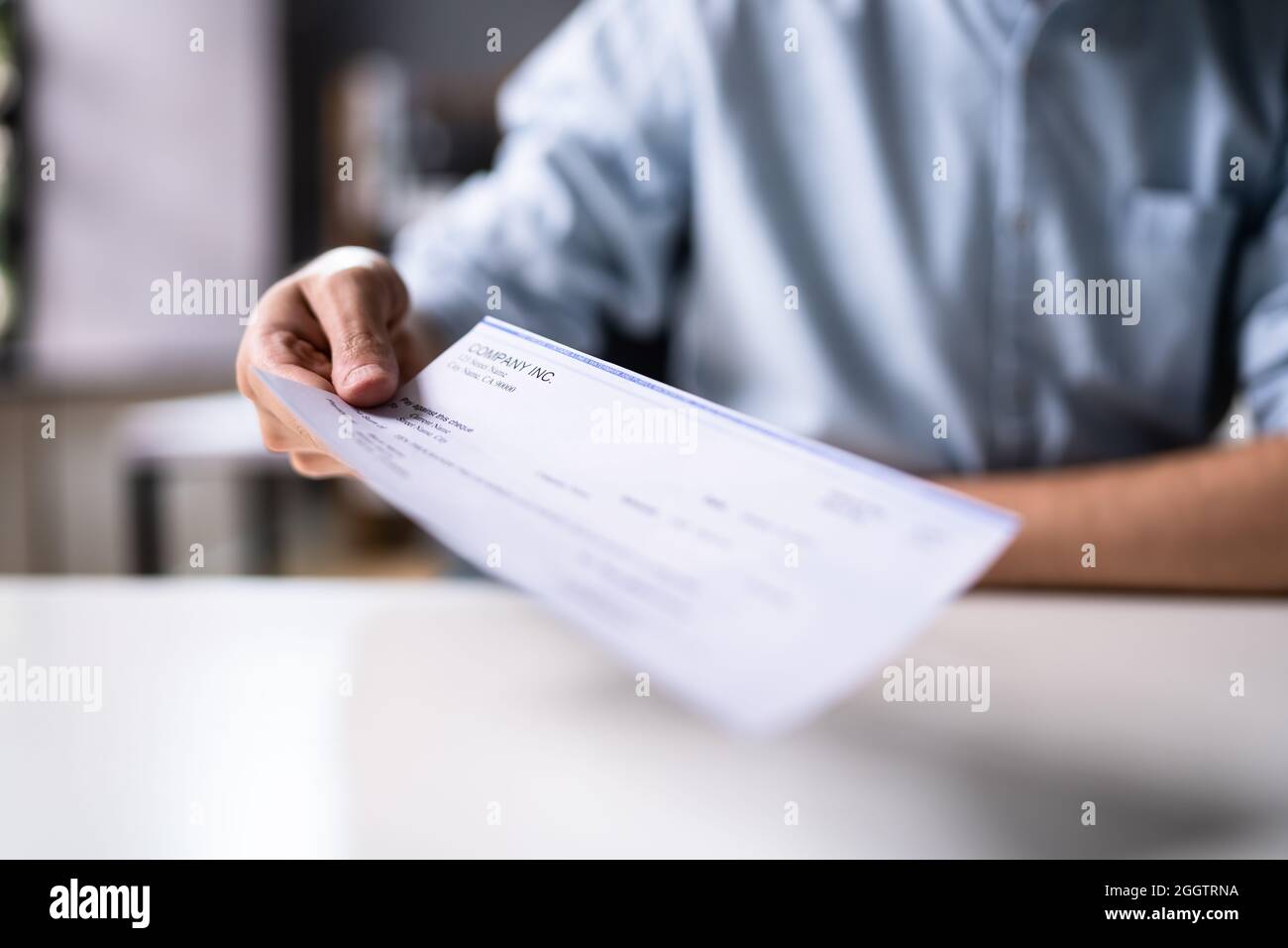 Hand Giving Payment Check Or Compensation Cheque Stock Photo - Alamy