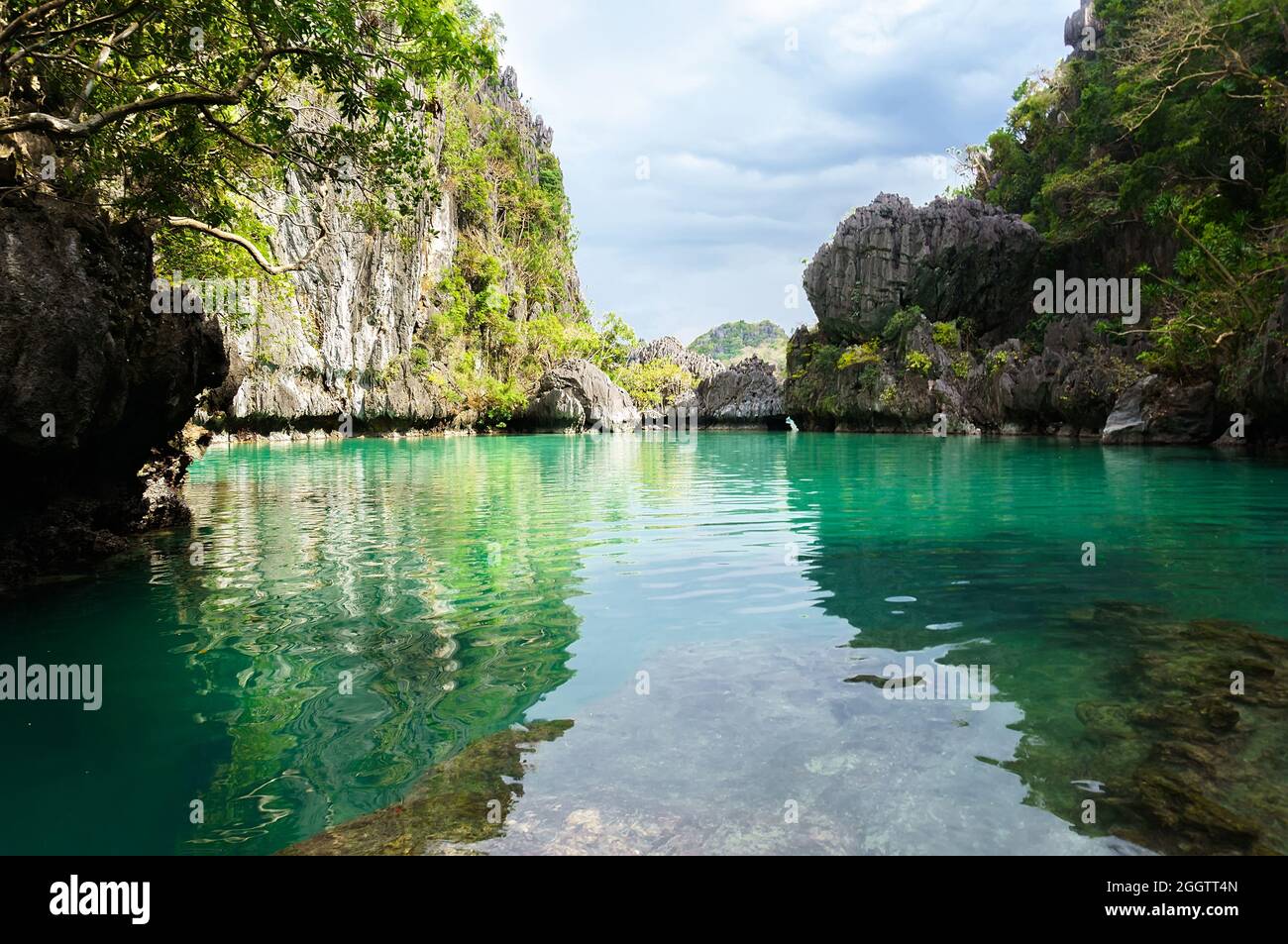 beautiful lagoon with crystal clear turquoise water surrounded by high ...