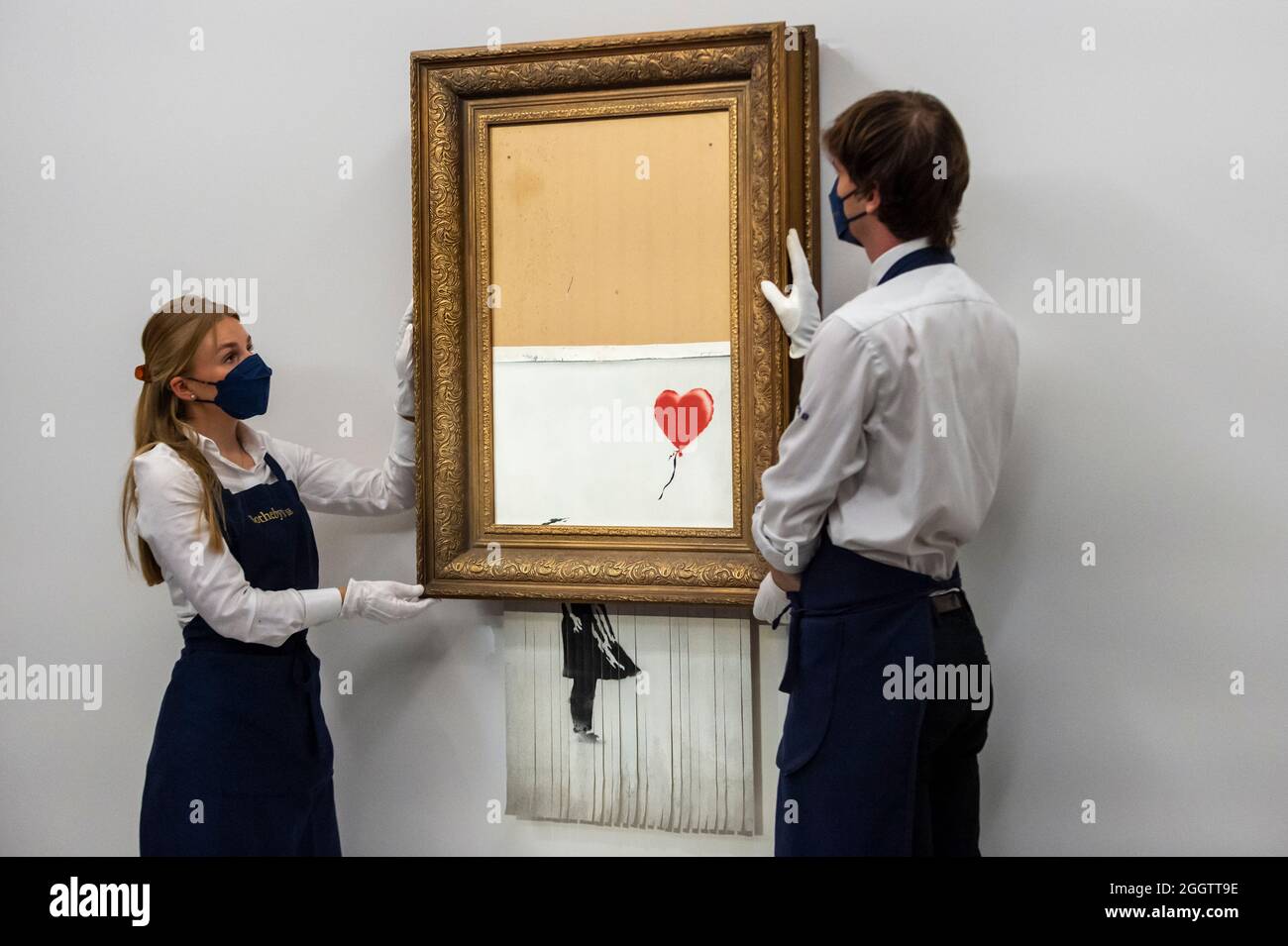 Banksy girl with balloon shredded art hi-res stock photography and ...