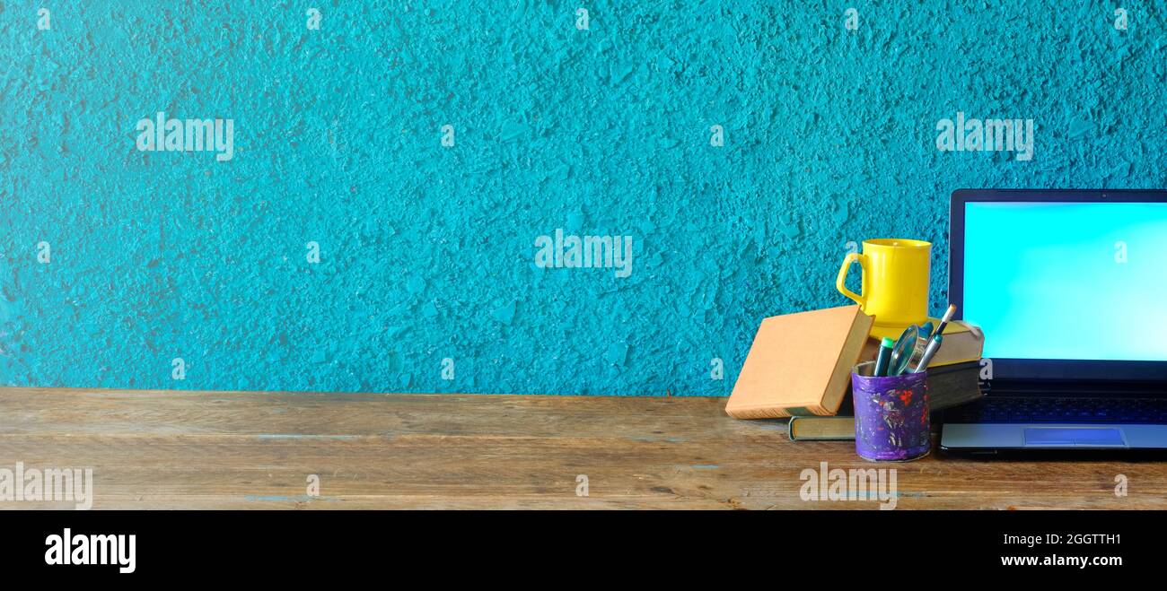 Stack of books laptop computer and office supplies,home office ...