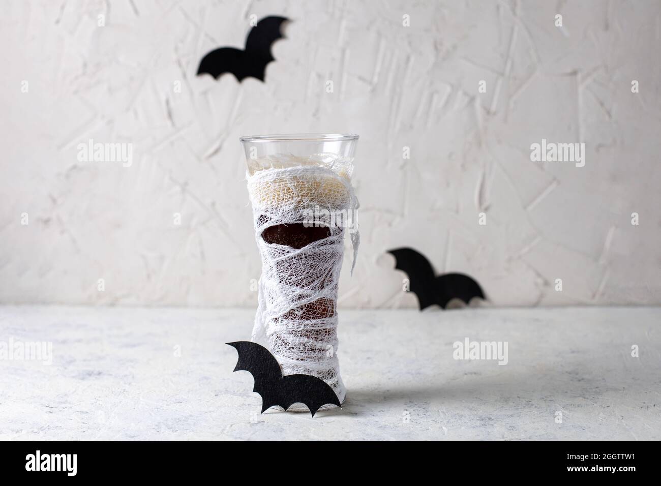 Glass of cocktail decorated as mummy. Drink for a halloween party for ...