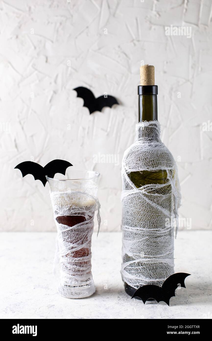 Glass and Bottle of cocktail decorated as mummy. Drink for a halloween ...