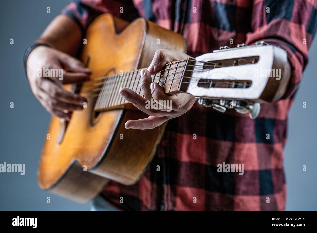 Guitars and strings. Man playing guitar, holding an acoustic guitar in ...