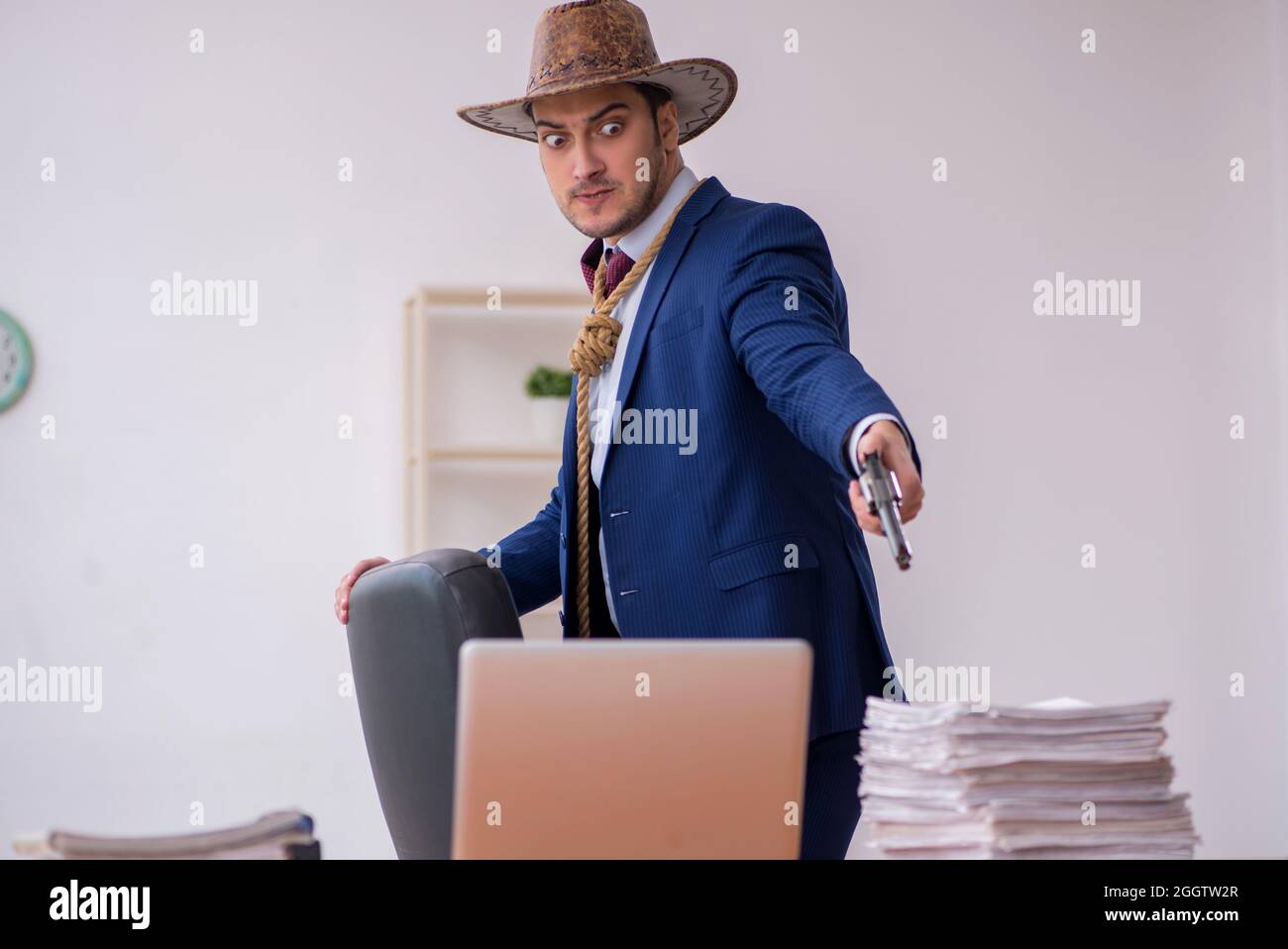 Young cowboy employee working at workplace Stock Photo - Alamy
