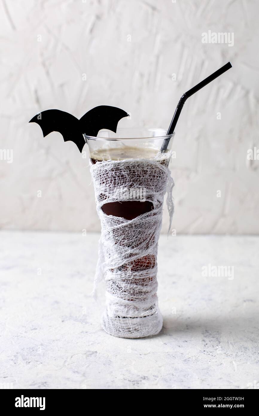 Glass of cocktail decorated as mummy. Drink for a halloween party for ...
