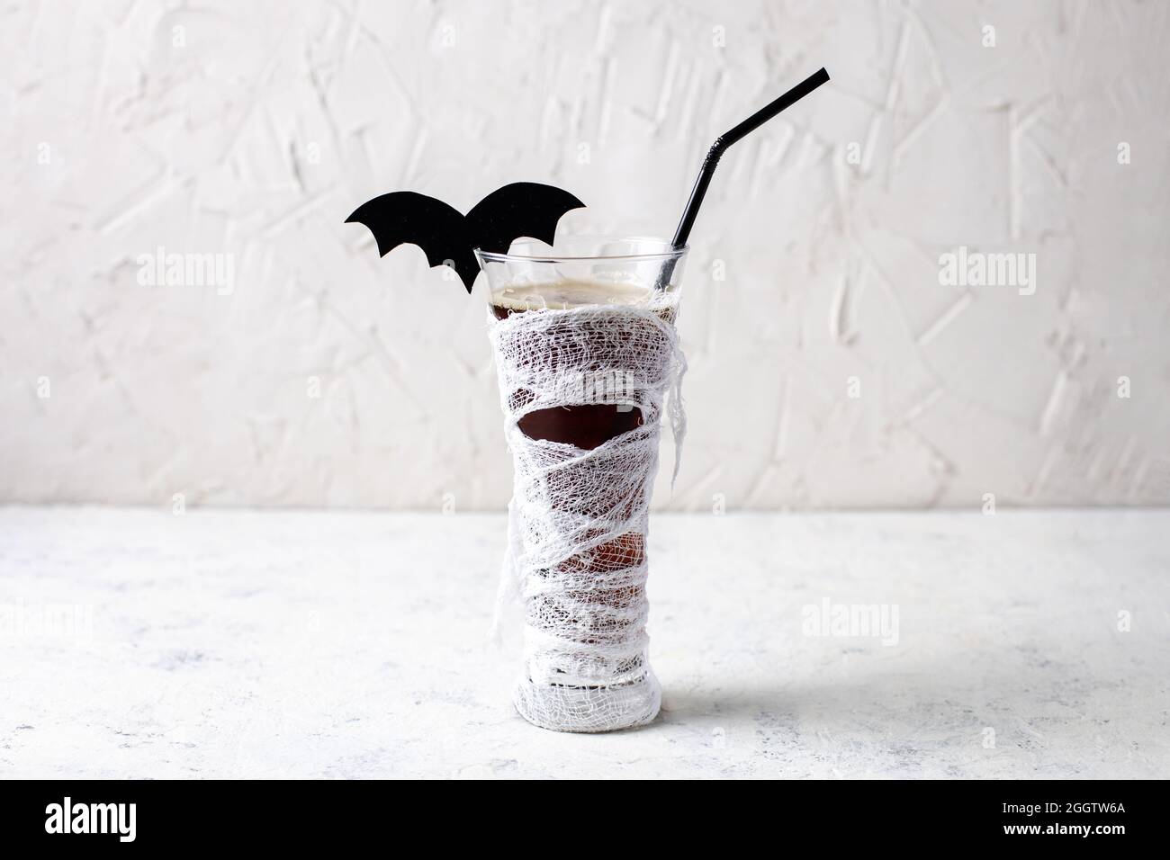 Glass of cocktail decorated as mummy. Drink for a halloween party for ...