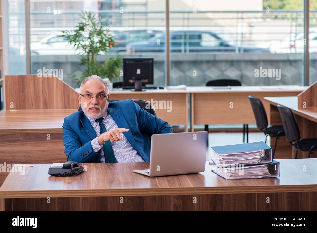 Old employee working in the office Stock Photo - Alamy