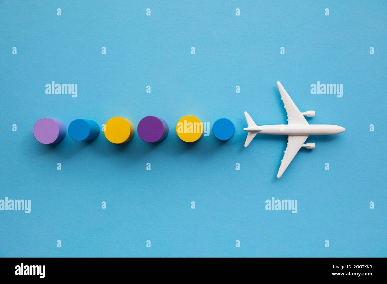 Travel background with a toy airplane and colourful circular blocks ...