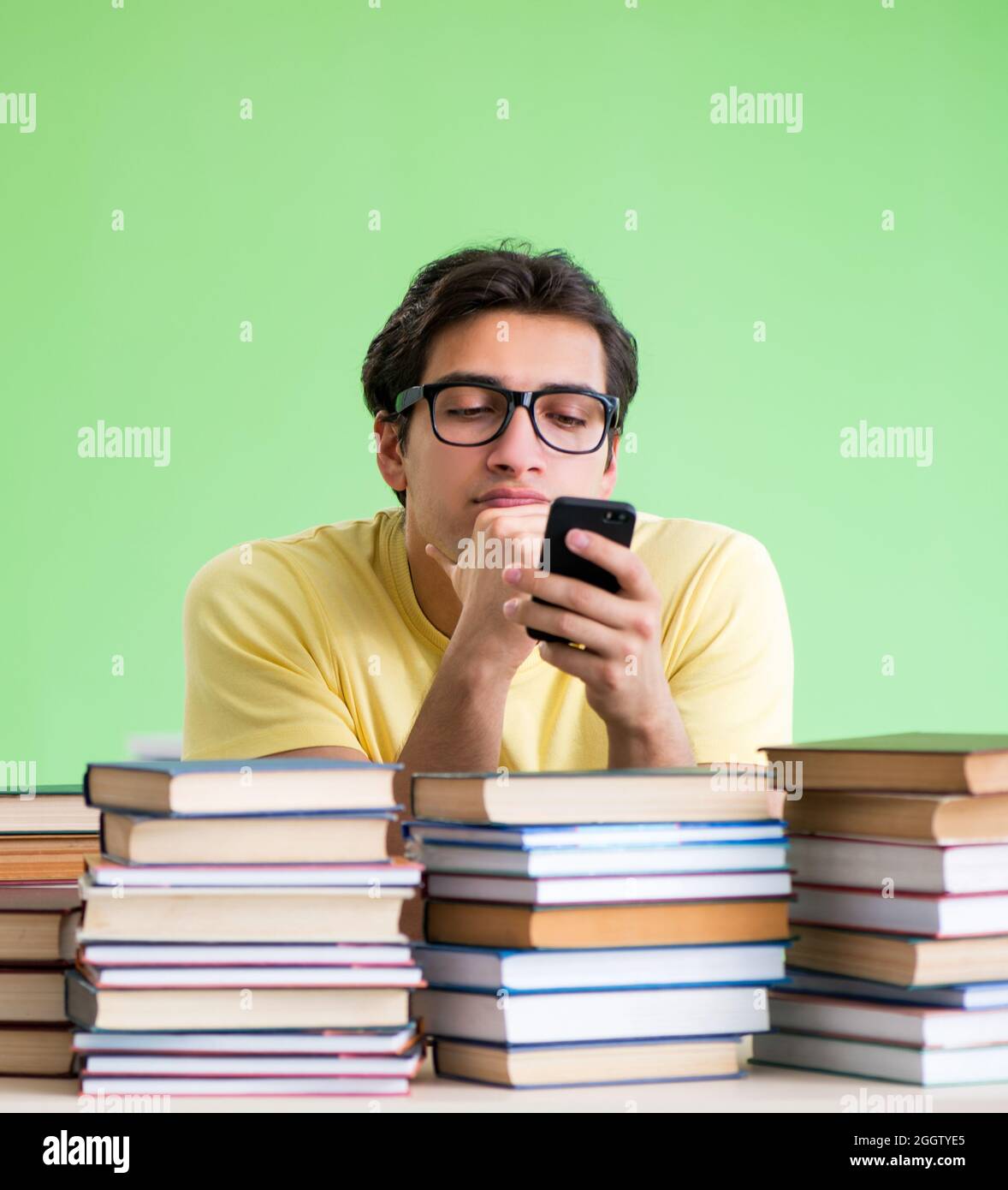 The student with too many books to read before exam Stock Photo - Alamy