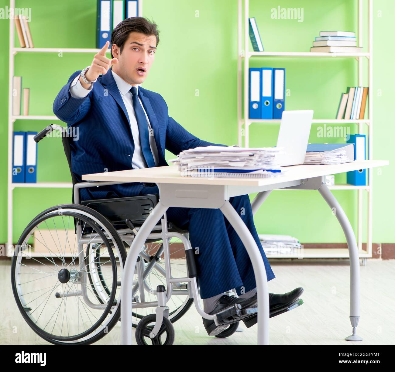 The disabled businessman working in the office Stock Photo - Alamy