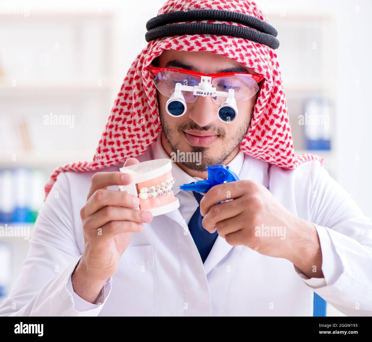 The arab dentist working on new teeth implant Stock Photo - Alamy