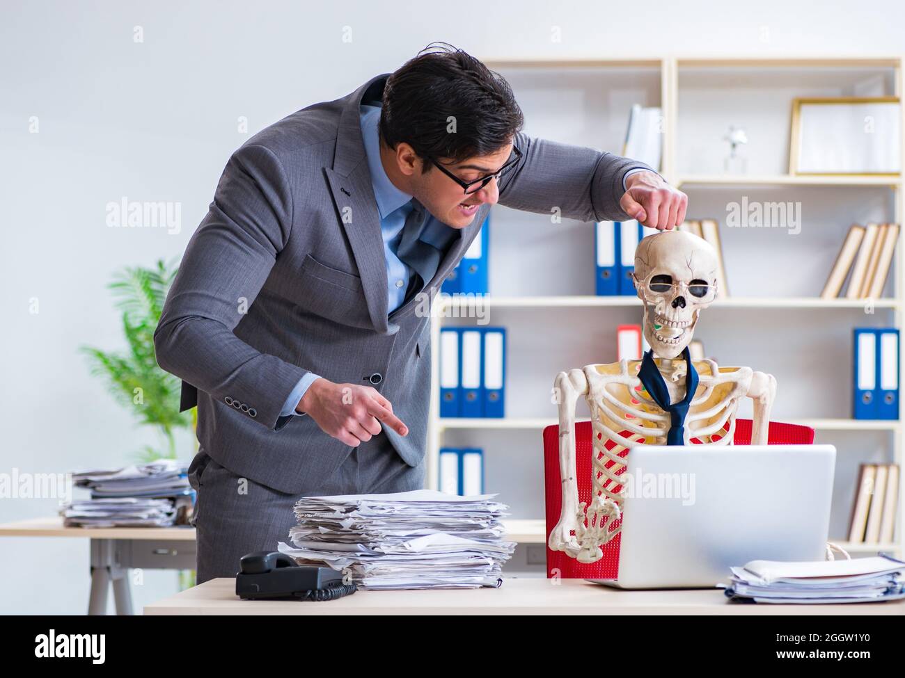 The angry boss yelling at his skeleton employee Stock Photo - Alamy