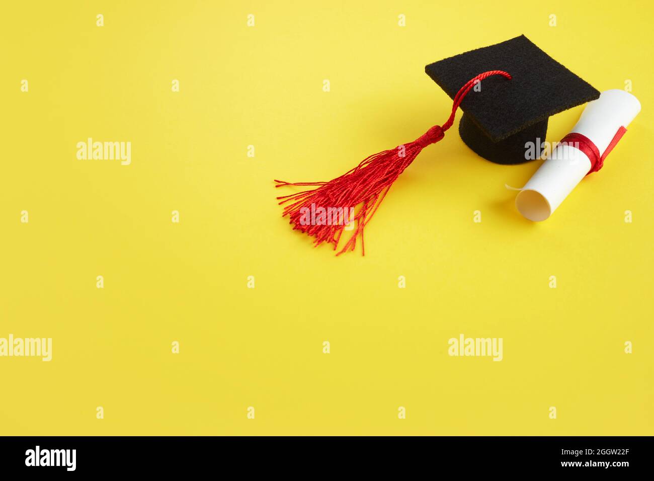 Academic hat with diploma on yellow background. Graduation theme Stock ...