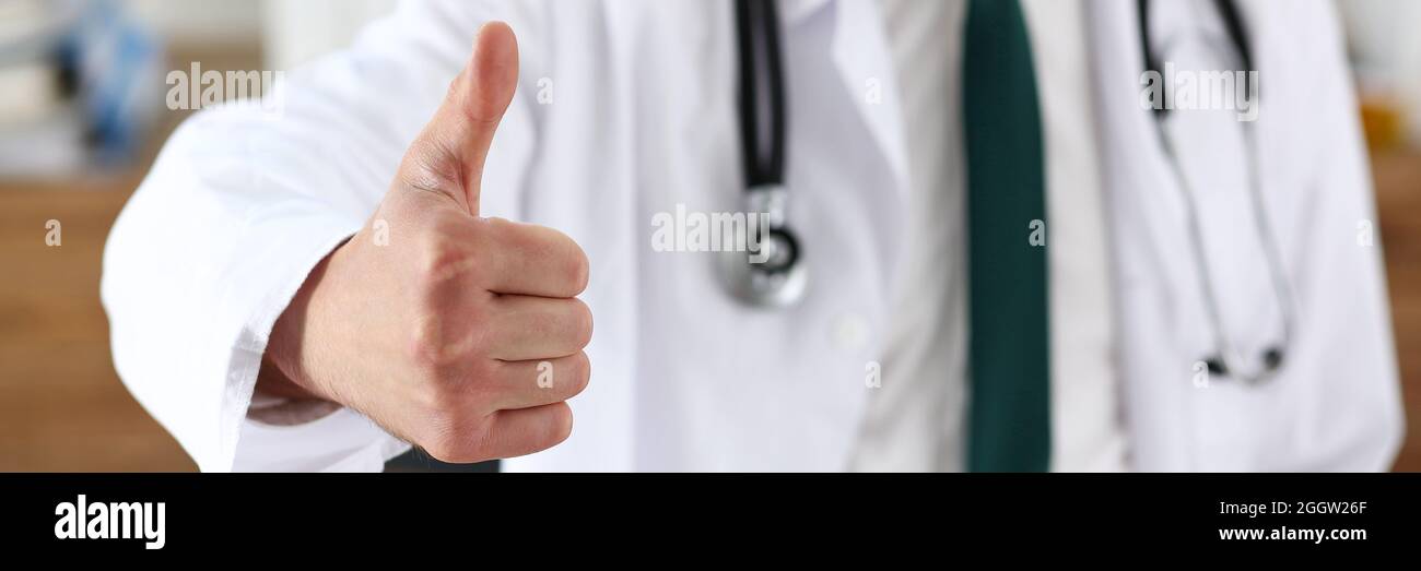 Smiling male medicine doctor showing OK sign with thumb up Stock Photo ...