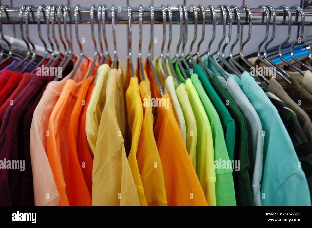 Colorful clothes on hangers in wardrobe Stock Photo - Alamy