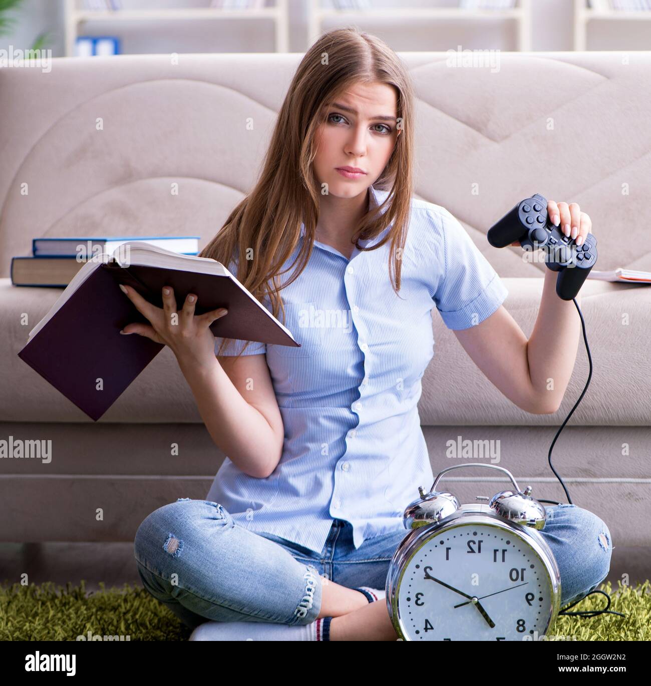 The female student being distracted from exam preparation Stock Photo ...