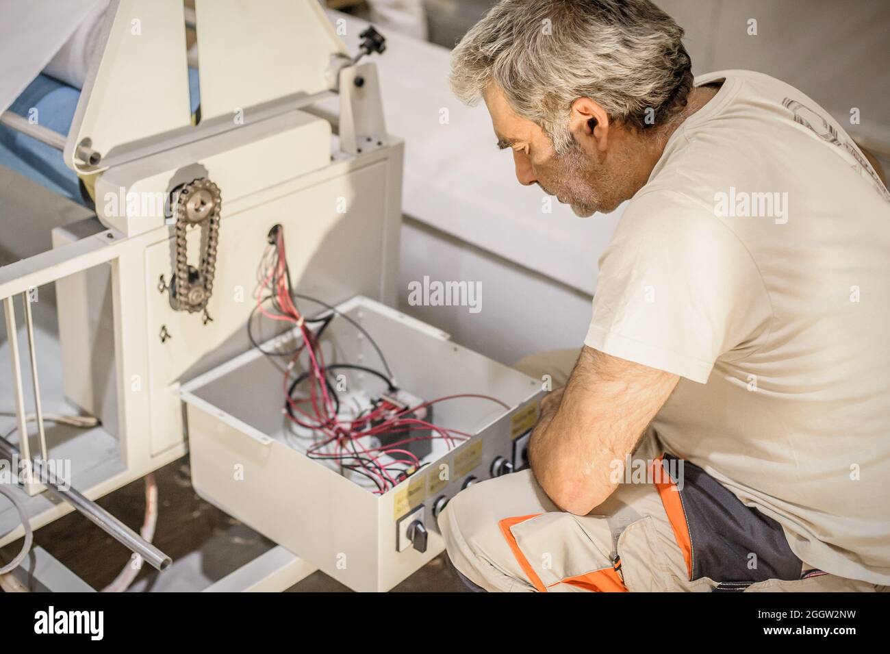 Close up of electrician engineer works with electric cable wires ...