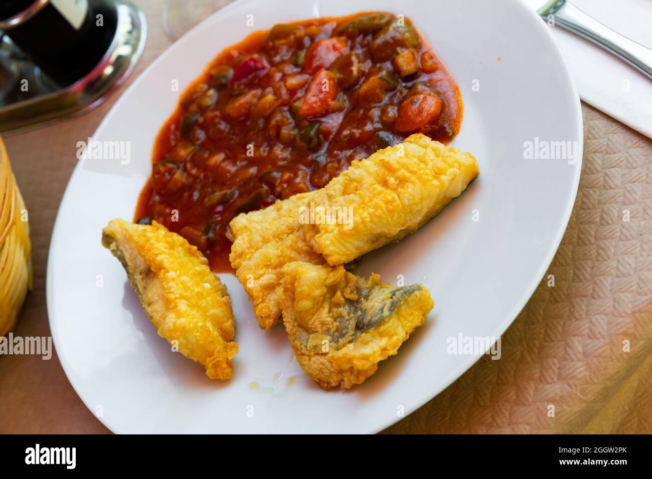 Roasted cod fish with stewed vegetables Stock Photo - Alamy