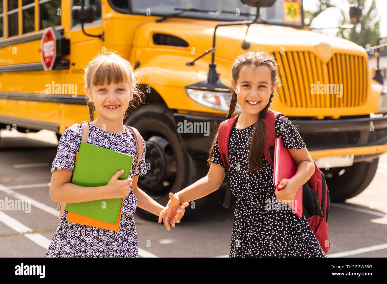 Two little kids going to school together Stock Photo - Alamy