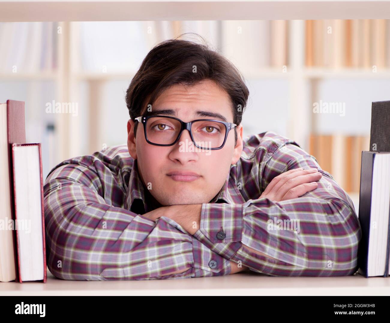 The young student looking for books in college library Stock Photo - Alamy