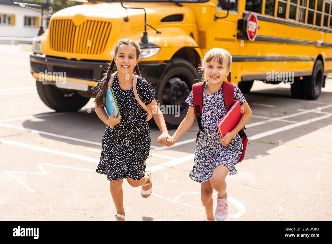 Two little kids going to school together Stock Photo - Alamy