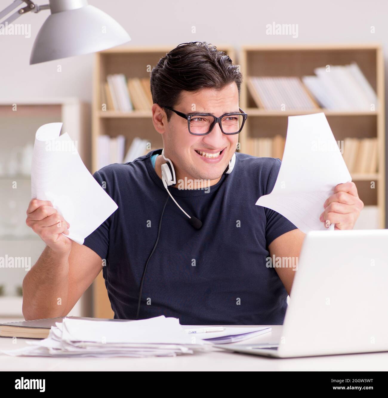 The angry man tearing apart his paperwork due to stress Stock Photo - Alamy